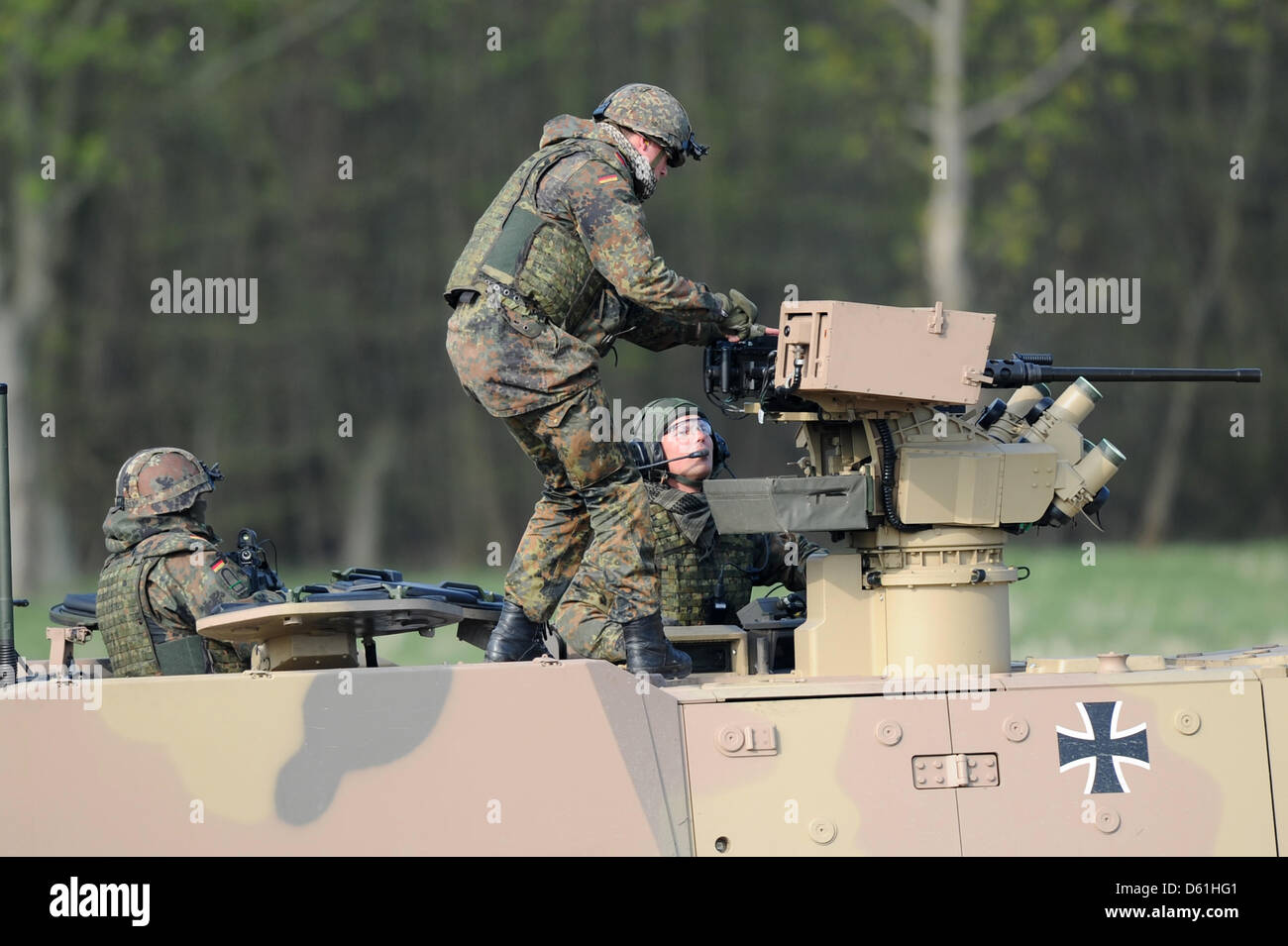 A soldier loads the machine gun of a GTK Boxer type during a ...