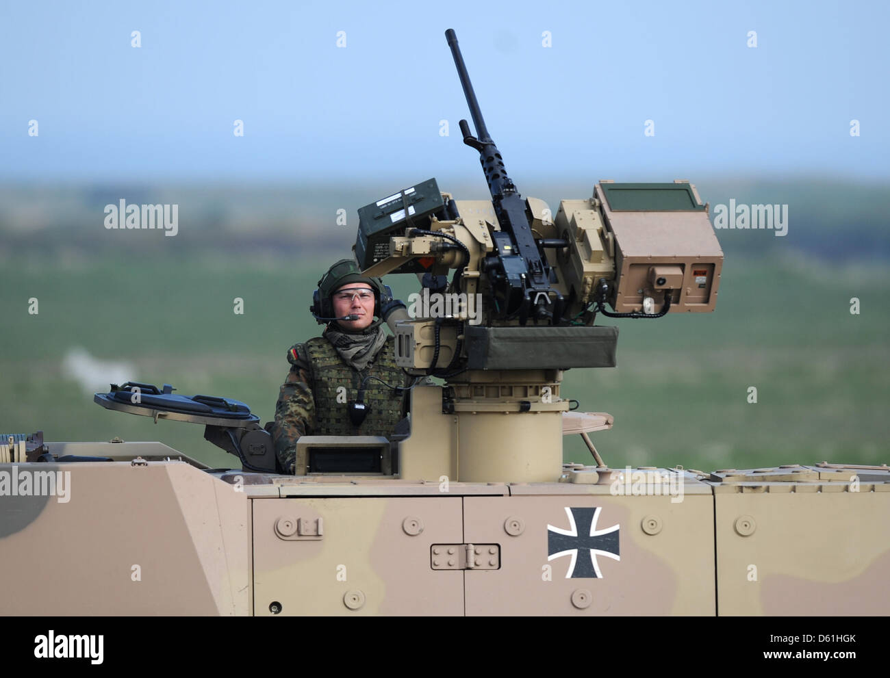 A soldier looks out of an armoured fighting vehicle of the GTK Boxer ...