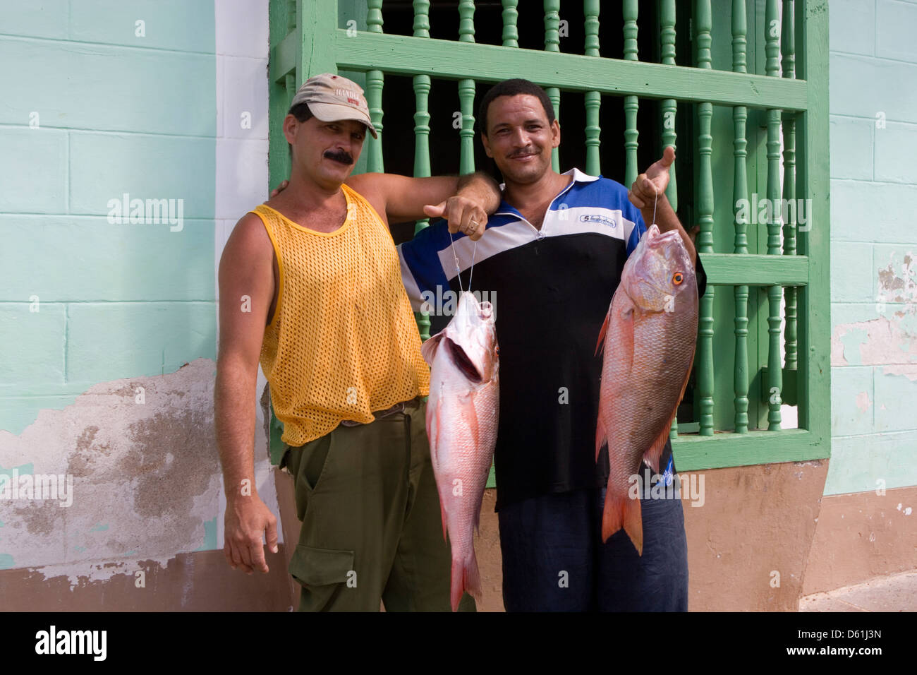 Trinidad: fishermen with sea-bass Stock Photo - Alamy
