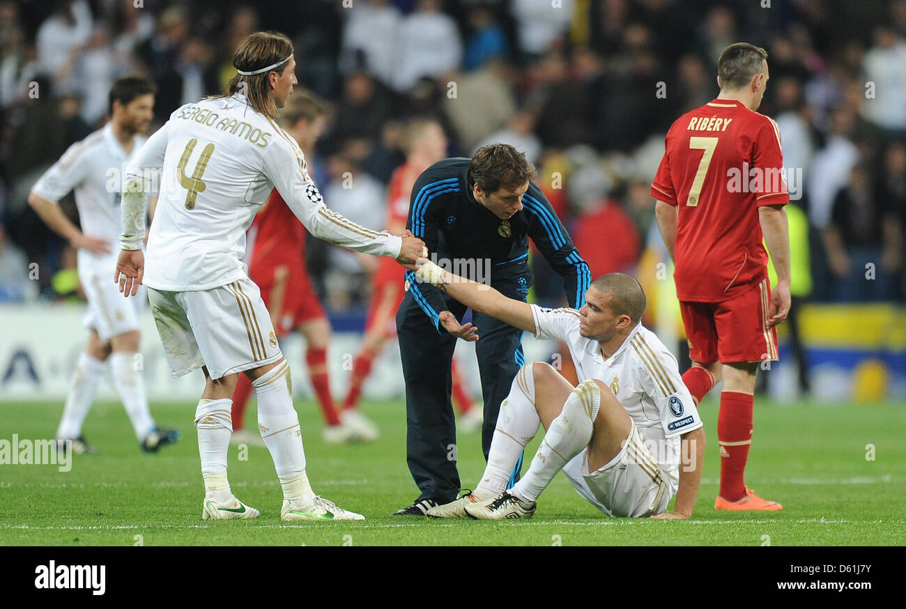 Madrid's Sergio Ramos (L) helps to get up to his teammate Pepe (2-R ...