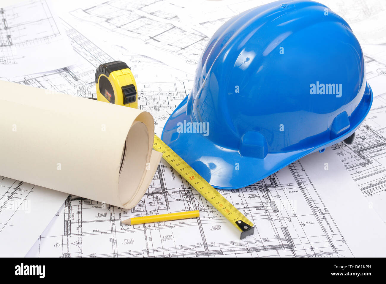 Blue hard hat, yellow pencil, measuring tape and building plans Stock ...