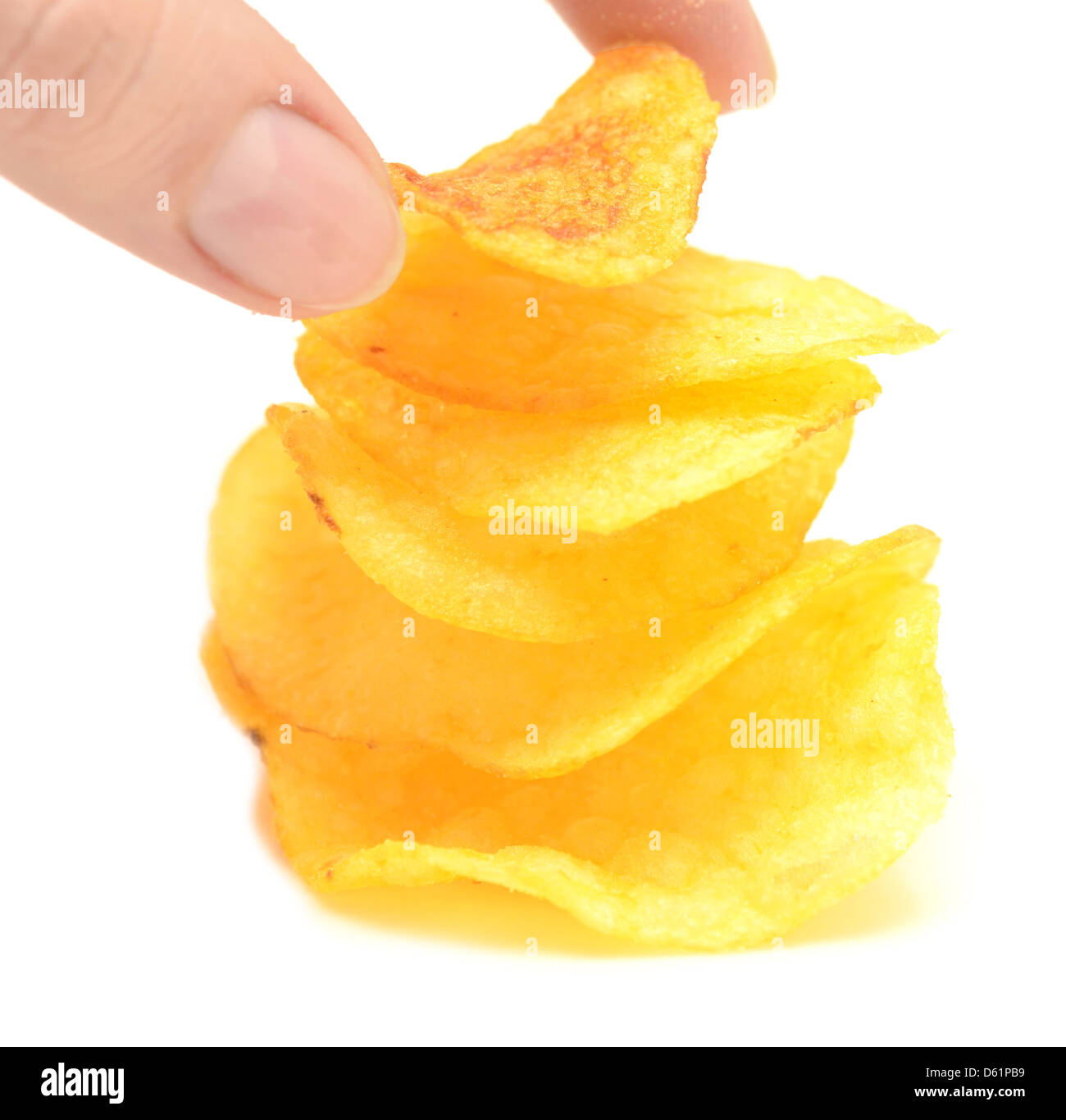 hand is placing potato chip Stock Photo - Alamy