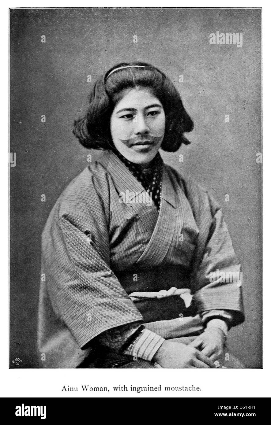 A 1901 photograph from 'A Ribbon of Iron', showing an Ainu woman with a ...