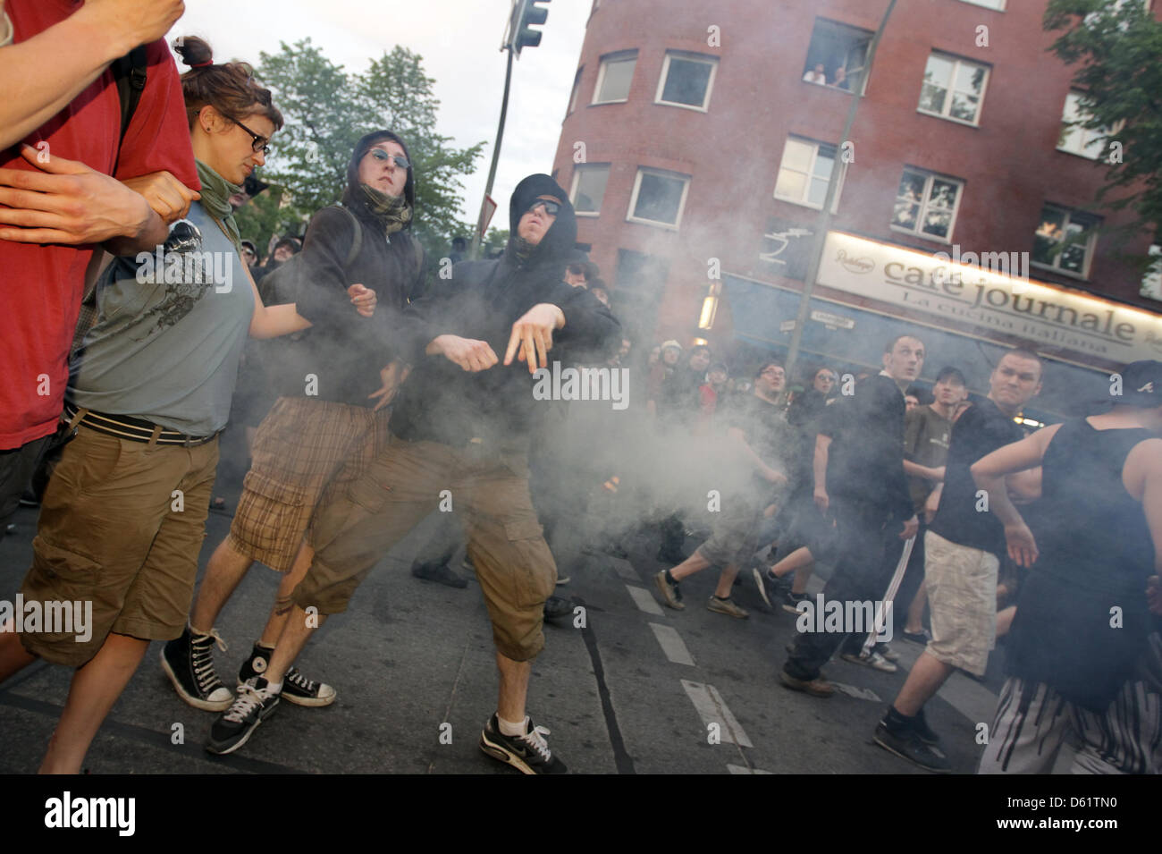 Protesters throw a smoke bomb during the 'Revolutionary May Day ...