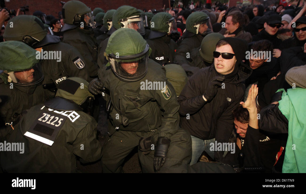 Police officers in riot gear confront protesters during the ...