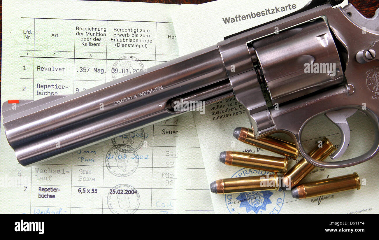 A female marksman loads her gun at a shooting range in Berlin, Germany ...