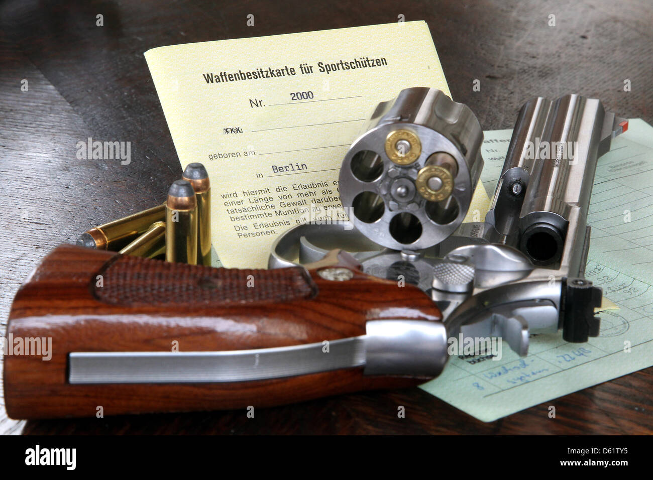 A female marksman loads her gun at a shooting range in Berlin, Germany ...