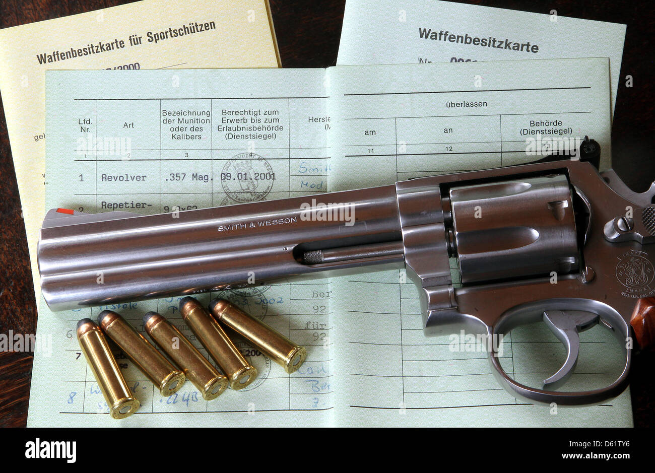 A female marksman loads her gun at a shooting range in Berlin, Germany ...