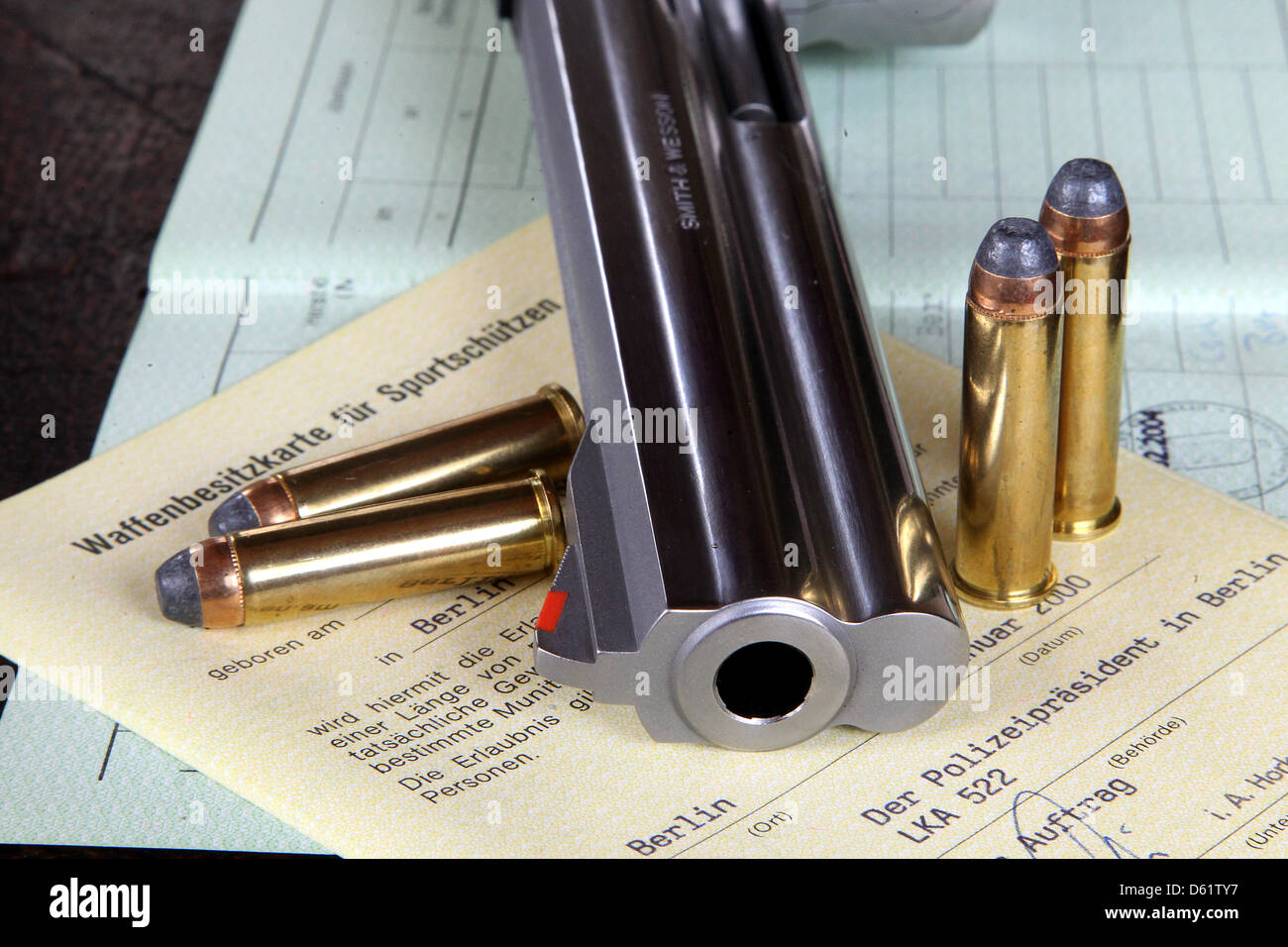 A female marksman loads her gun at a shooting range in Berlin, Germany ...