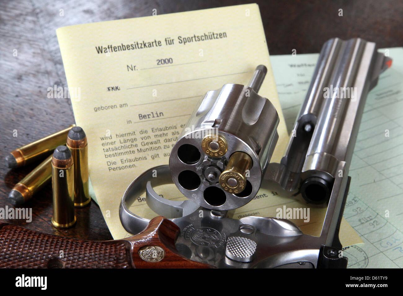 A female marksman loads her gun at a shooting range in Berlin, Germany ...