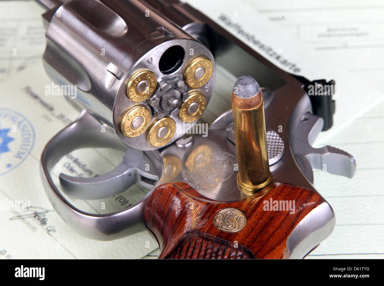 A female marksman loads her gun at a shooting range in Berlin, Germany ...