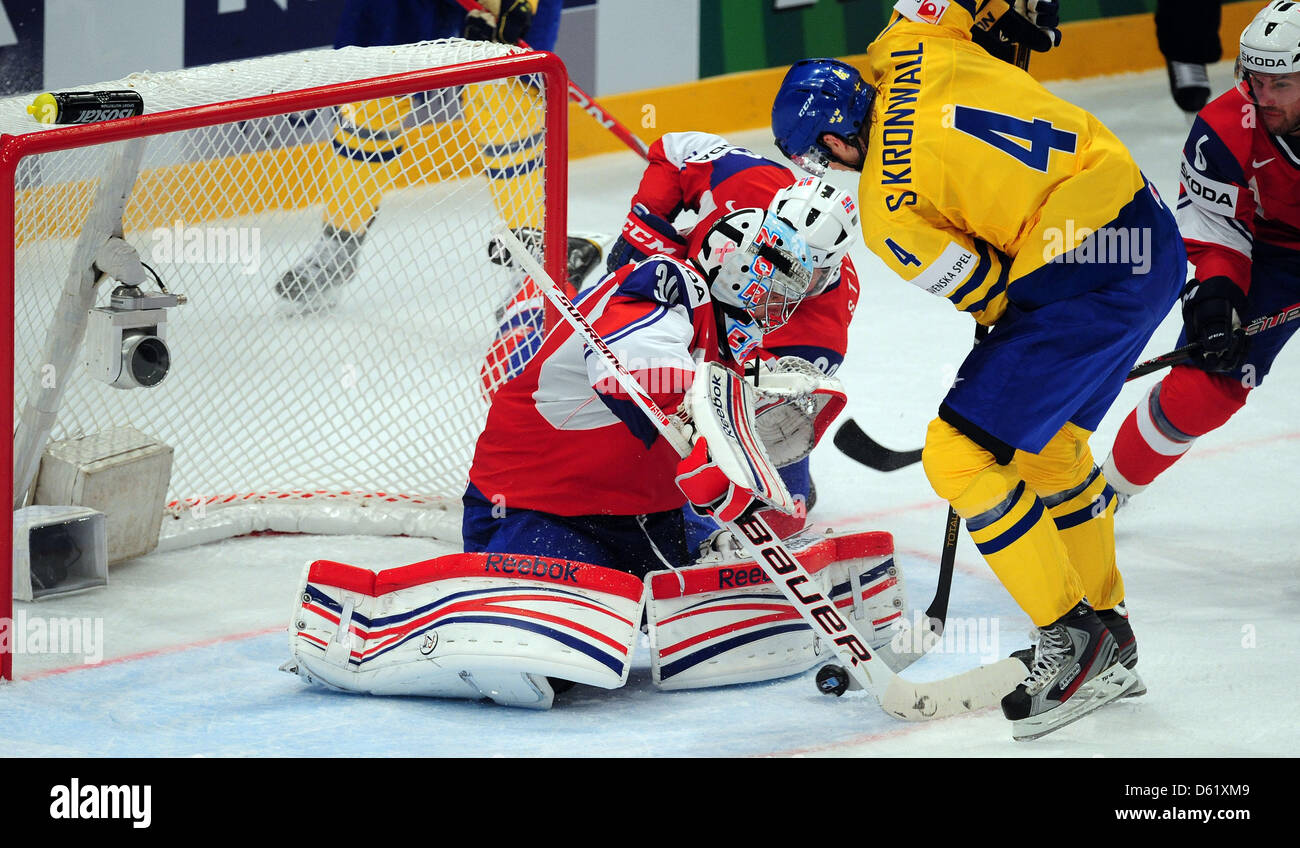 Sweden's Staffan Kronwall (r) and Norway's goalkeeper Lars Haugen fight ...