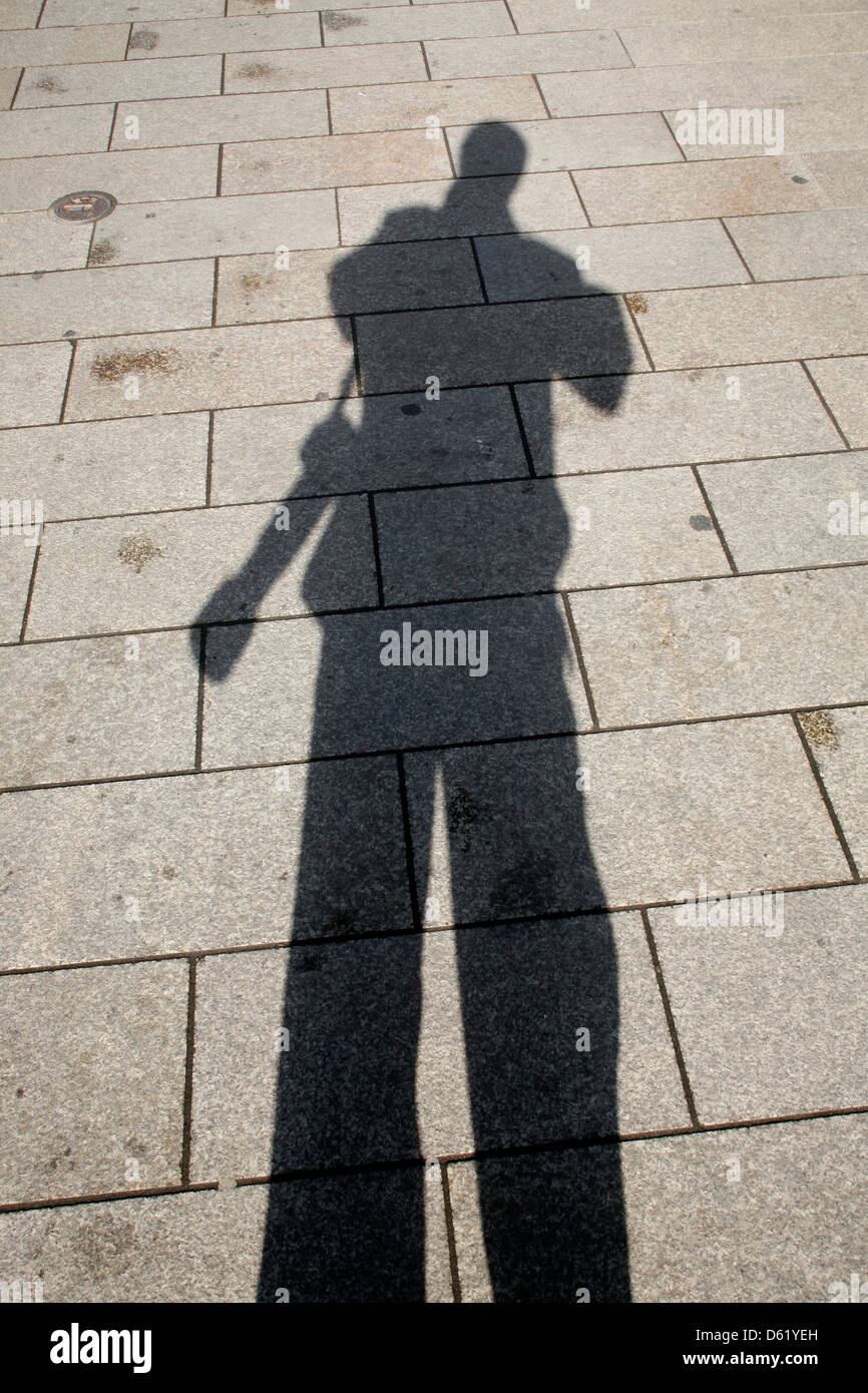 Long shadow of American camera totting Stock Photo - Alamy