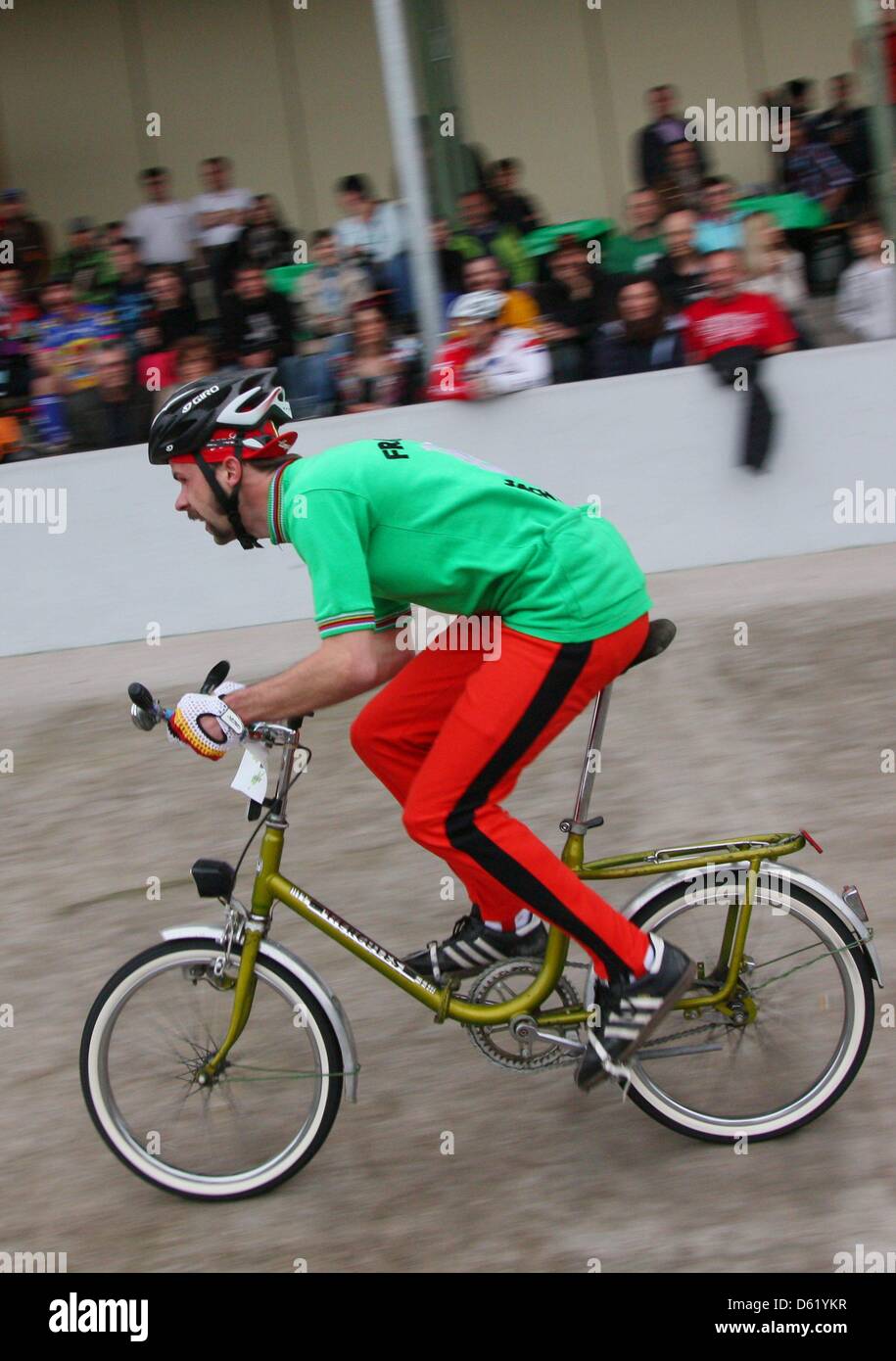 A participant in the first folding bike world championship competes in ...