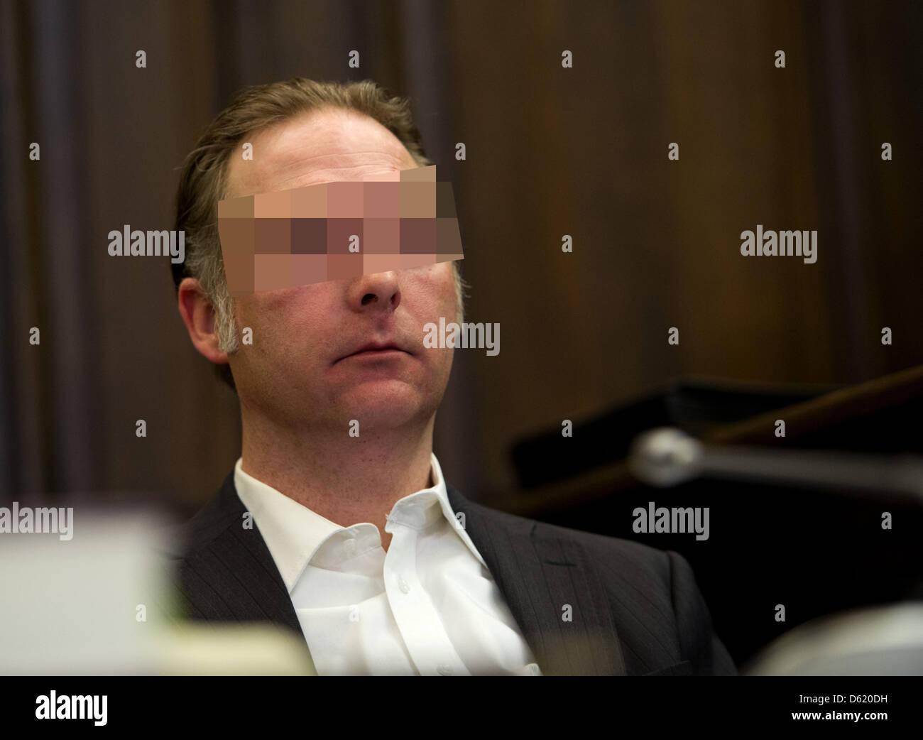 The defendant sits in the court room of the Regional Court in Hamburg ...