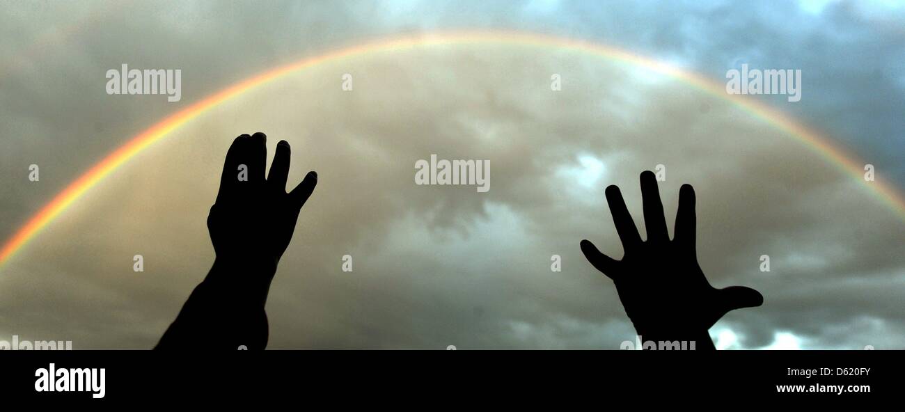 Two children's hands reach to a rainbow in Freiburg, Germany, 06 May ...
