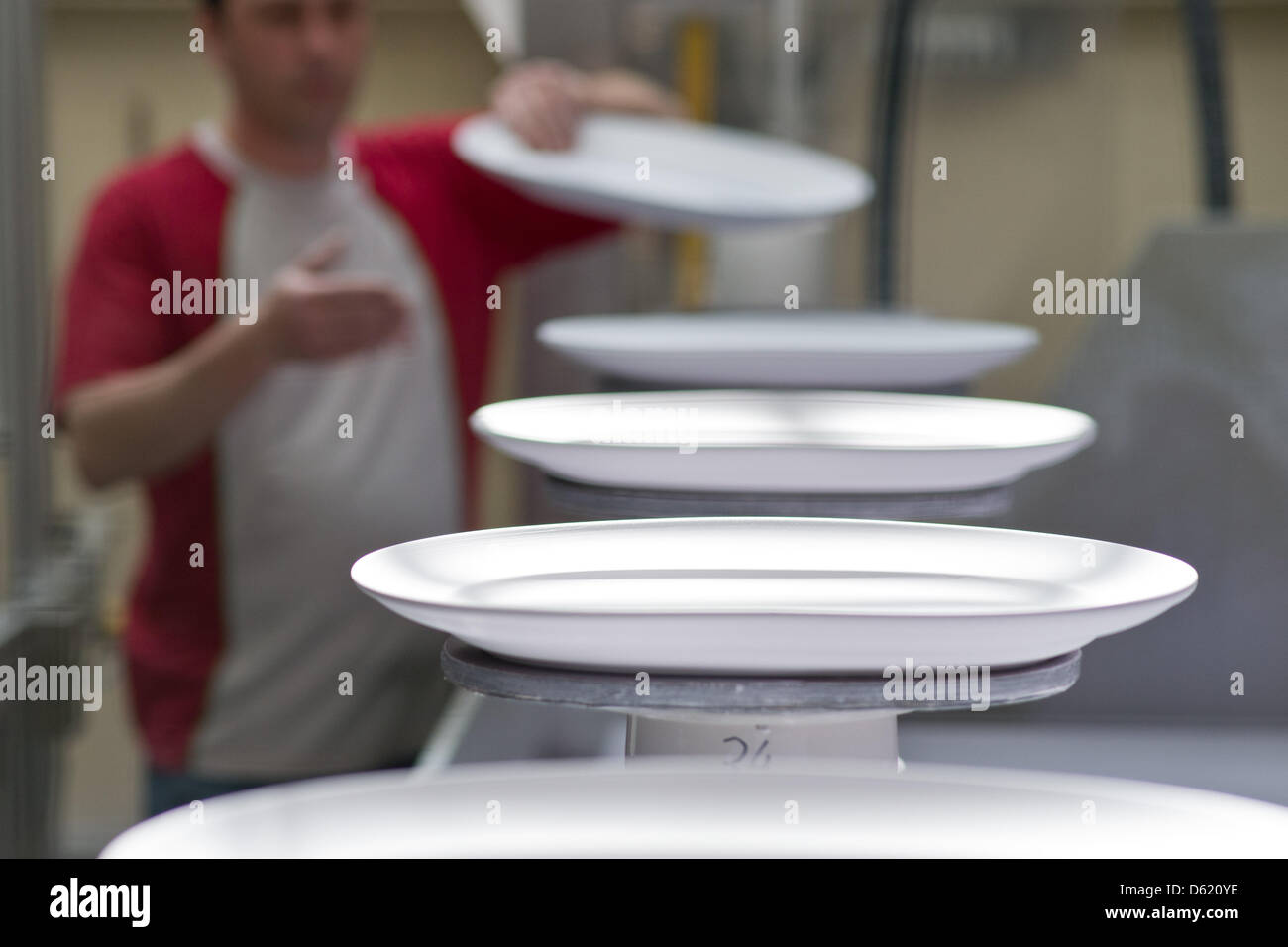 An employee sorts plates for the glazing at the BHS Tabletop cina ...