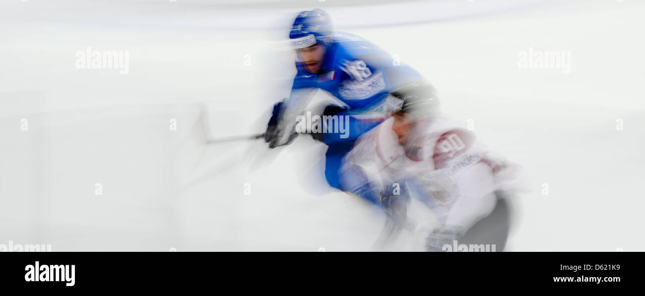 Latvia's Koba Jass (r) and Italy's Anton Bernard vie for the puck ...
