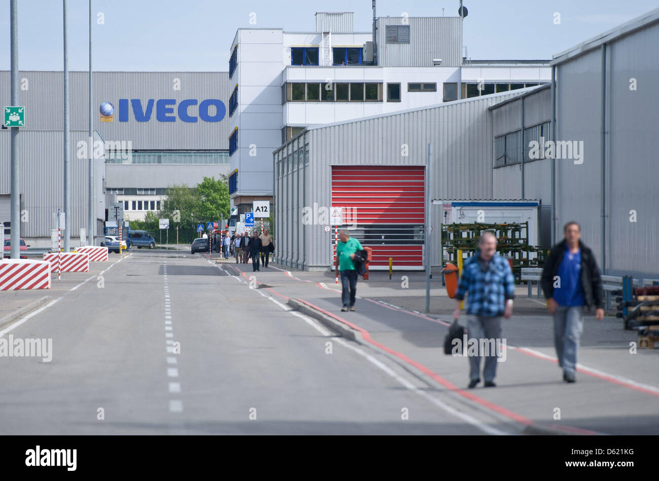 Iveco employees walk across the factory grounds in Ulm, Germany, 08 May ...