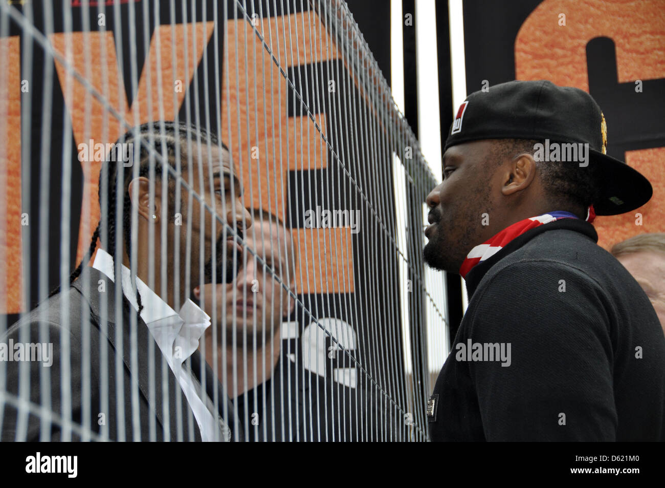 Suspended professional boxer Dereck Chisora (R) stands next to a fence ...