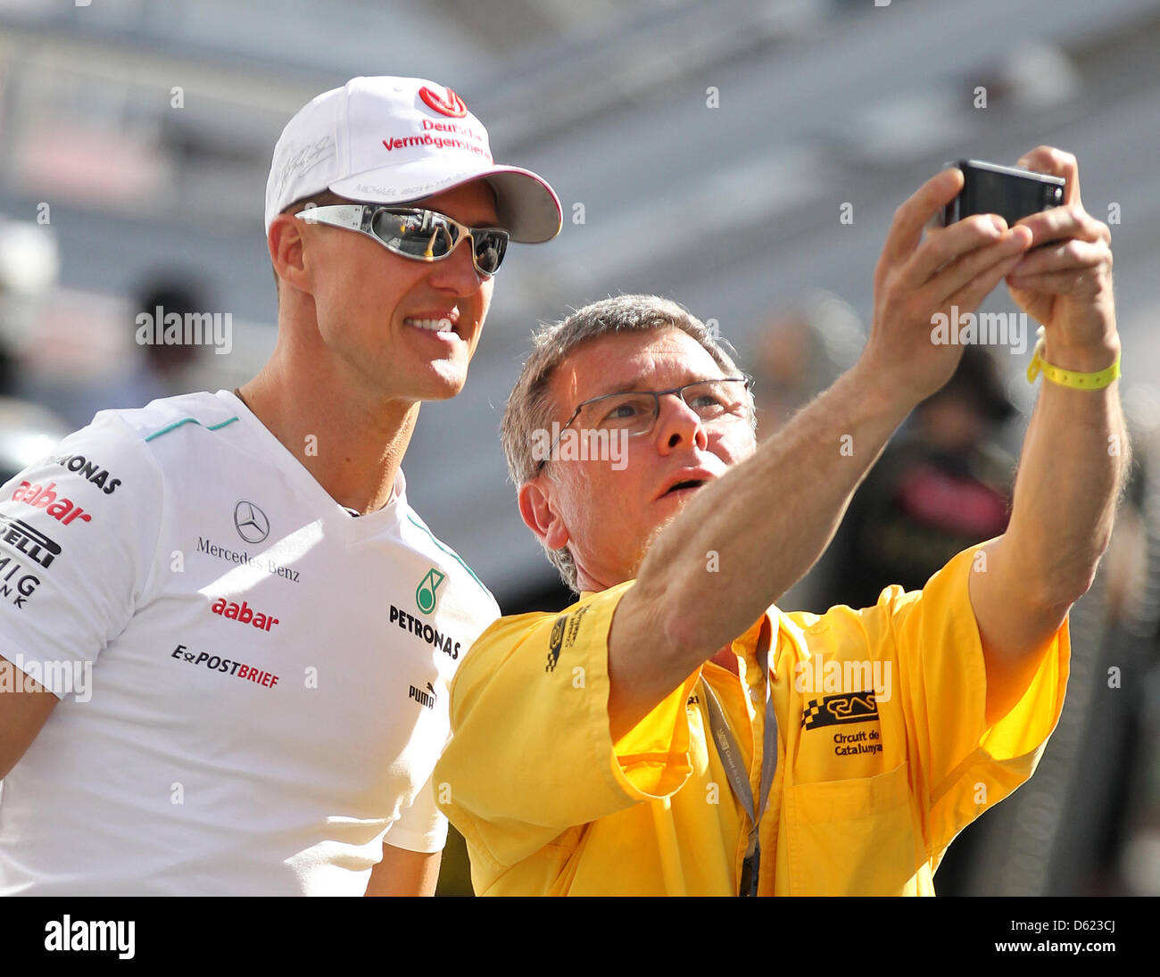German Formula One driver Michael Schumacher (L) of Mercedes AMG walks ...