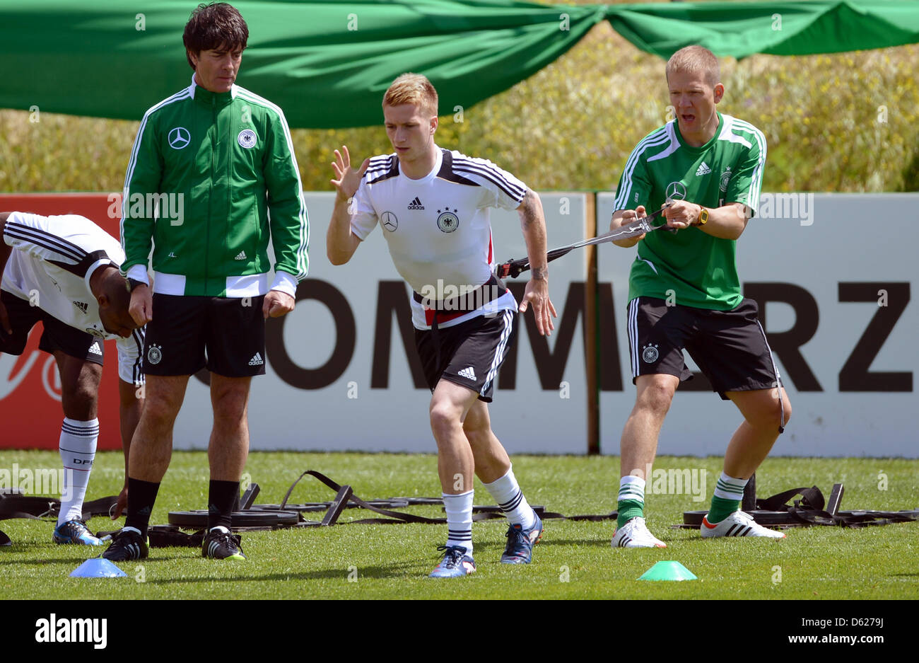 German national soccer coach Joachim Loew (L) watches his player Marco ...