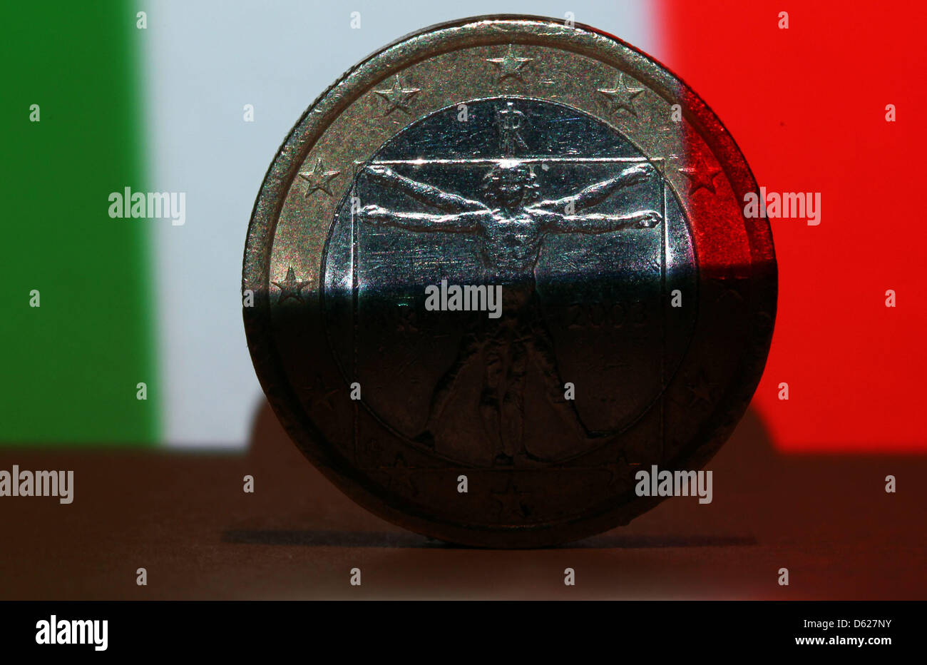ILLUSTRATION - An Italian euro coin stands on an Italian flag in ...