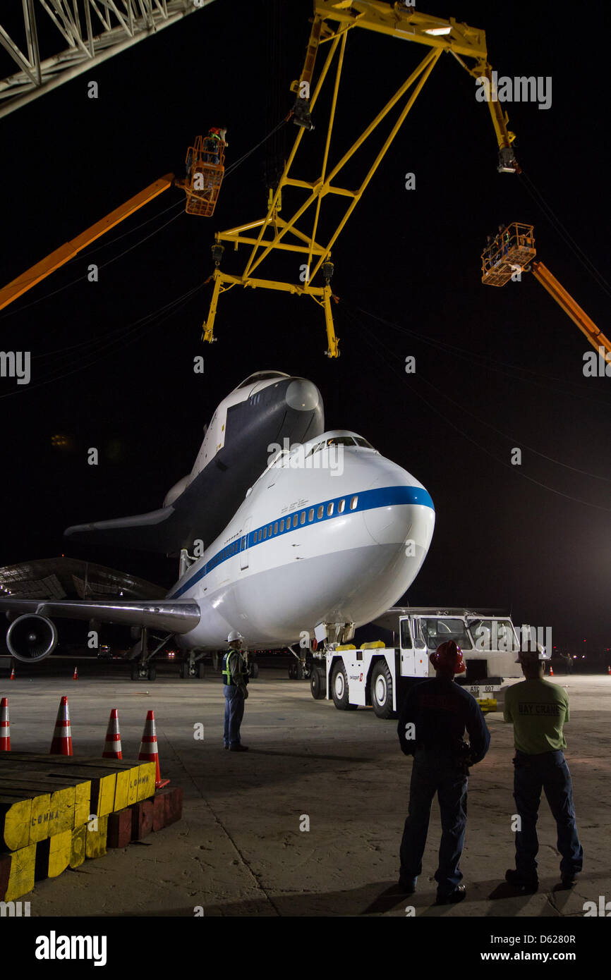 A yellow sling is lowered onto space shuttle Enterprise, which sits ...