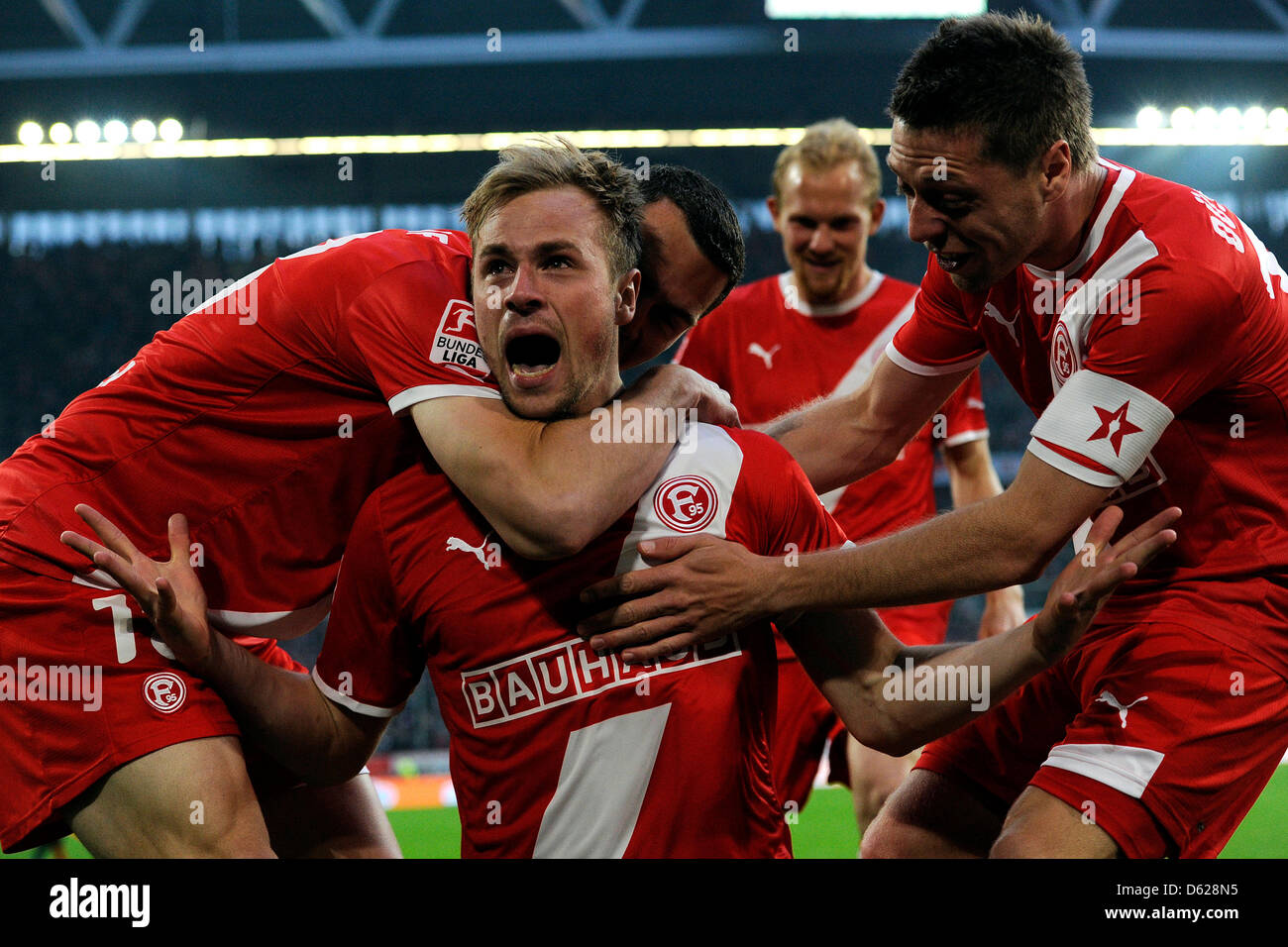 Duesseldorf's Thomas Broeker, goal scorer Maximilian Beister and ...