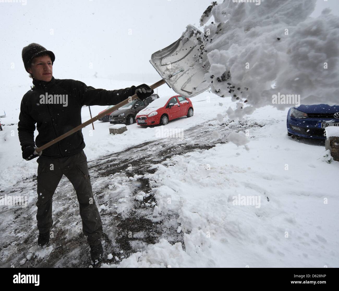 Malte Bueter shovels snow on Feldberg Mountain near Feldberg, Germany ...