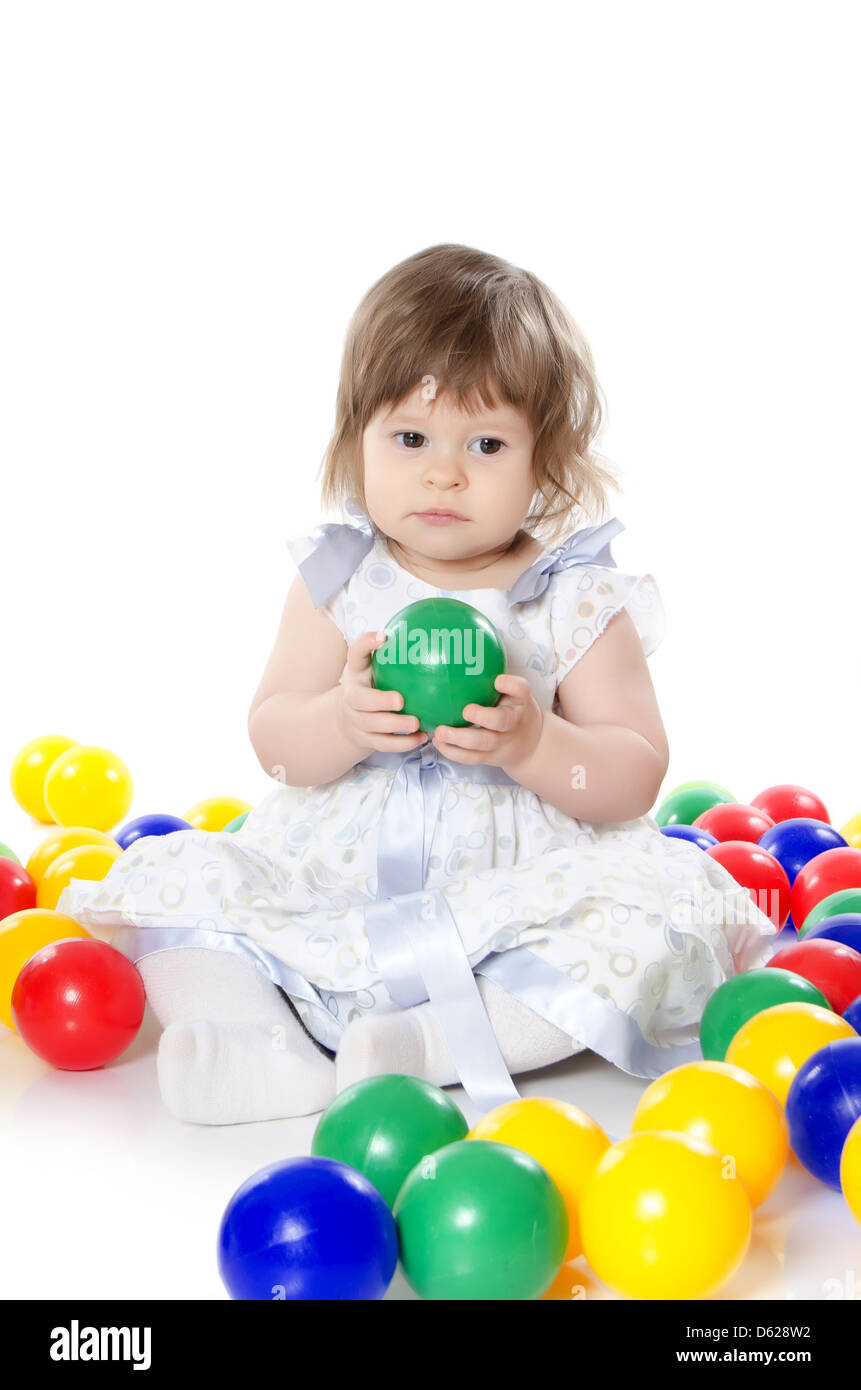 The little girl plays multi-coloured balls Stock Photo - Alamy