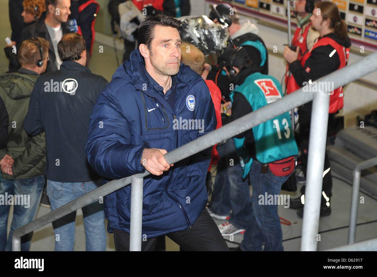 Berlin's acting manager Michael Preetz walks up a flight of stairs ...