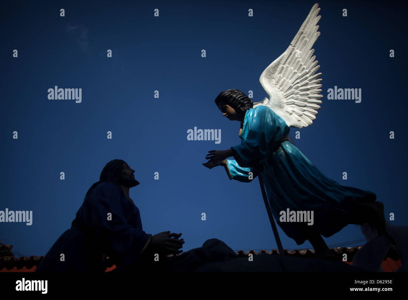 A silhouette of Jesus Christ praying in front of an angel is displayed ...