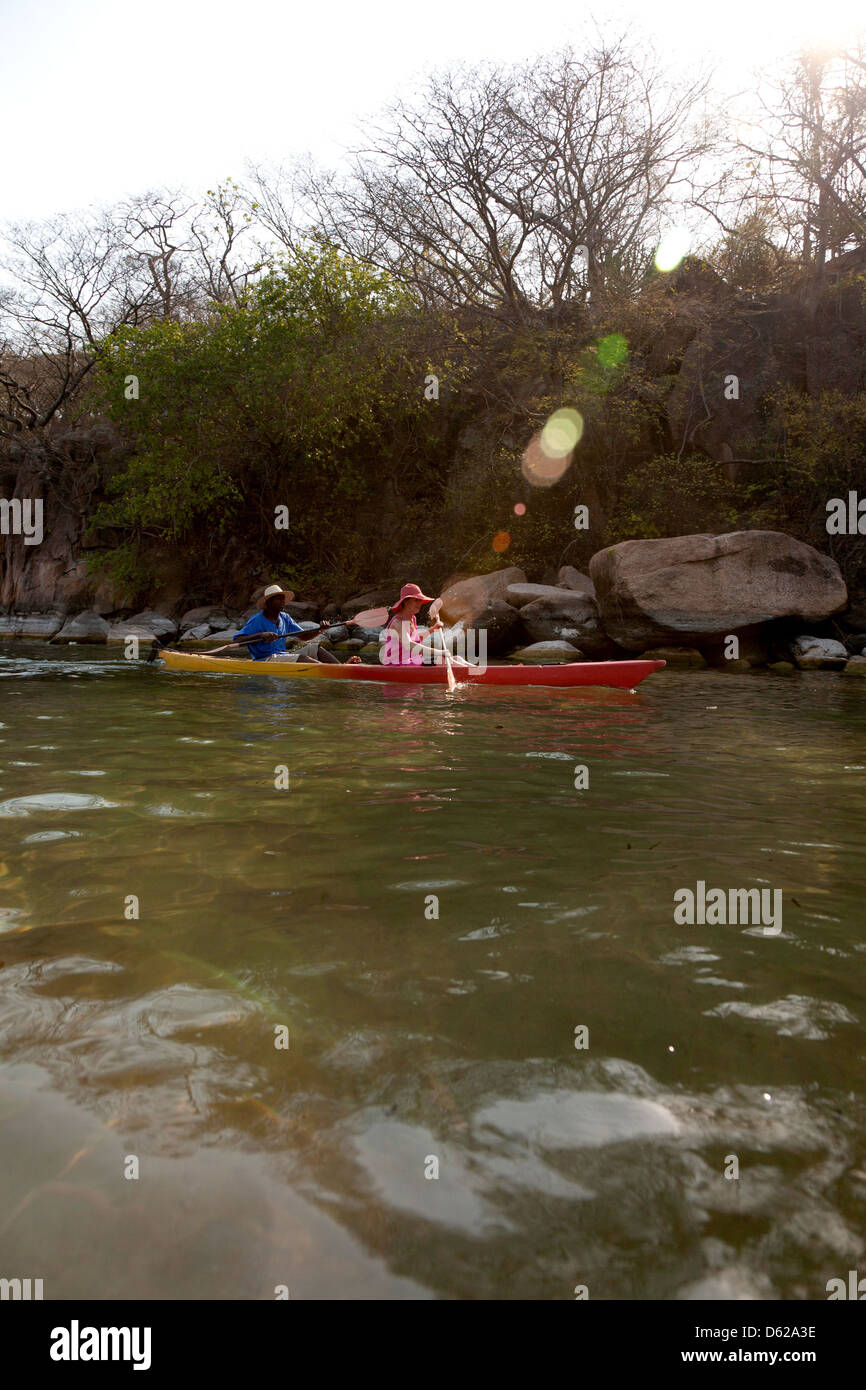 African guide takes tourist in canoe on ocean Stock Photo - Alamy