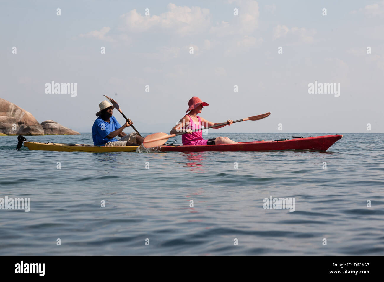 African guide takes tourist in canoe on ocean Stock Photo - Alamy
