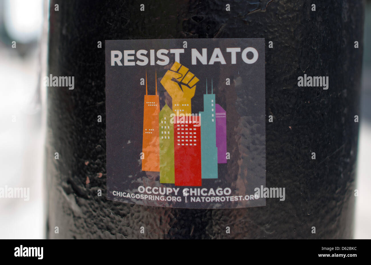 Resist NATO is written on a sticker stuck to a streetlight in Chicago ...
