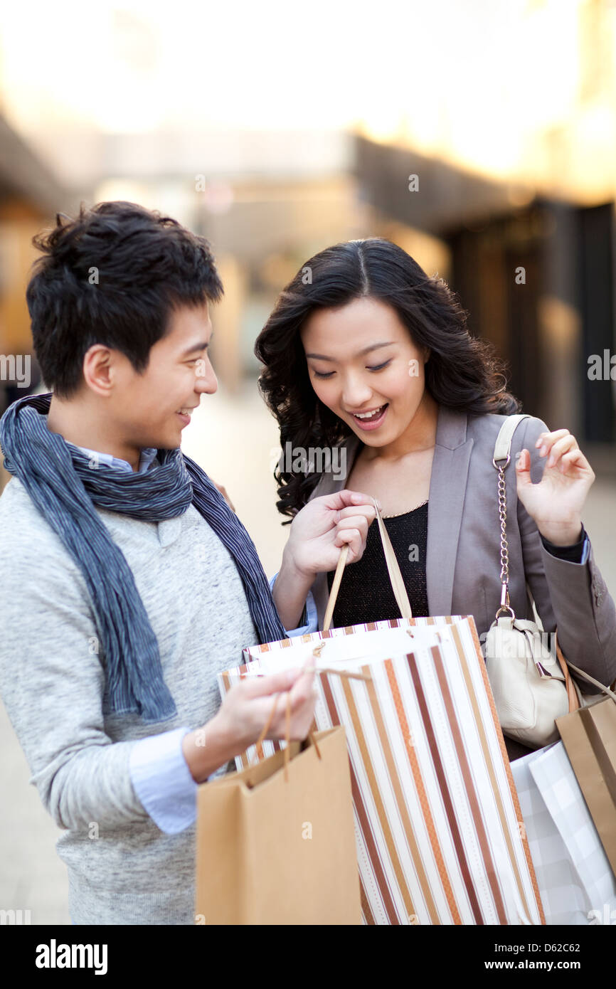 Excited young woman receiving a surprise gift from boyfriend Stock ...