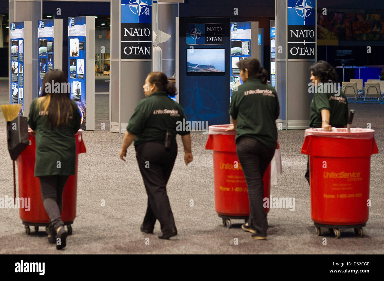 Cleaning personnel walks through the press centre of the NATO summit in ...