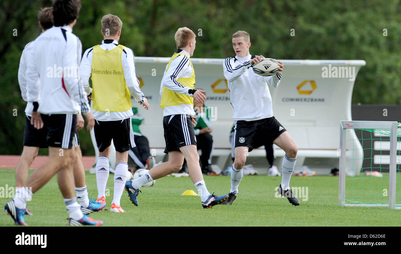 German national soccer player Sven Bender practices with a rugby ball ...