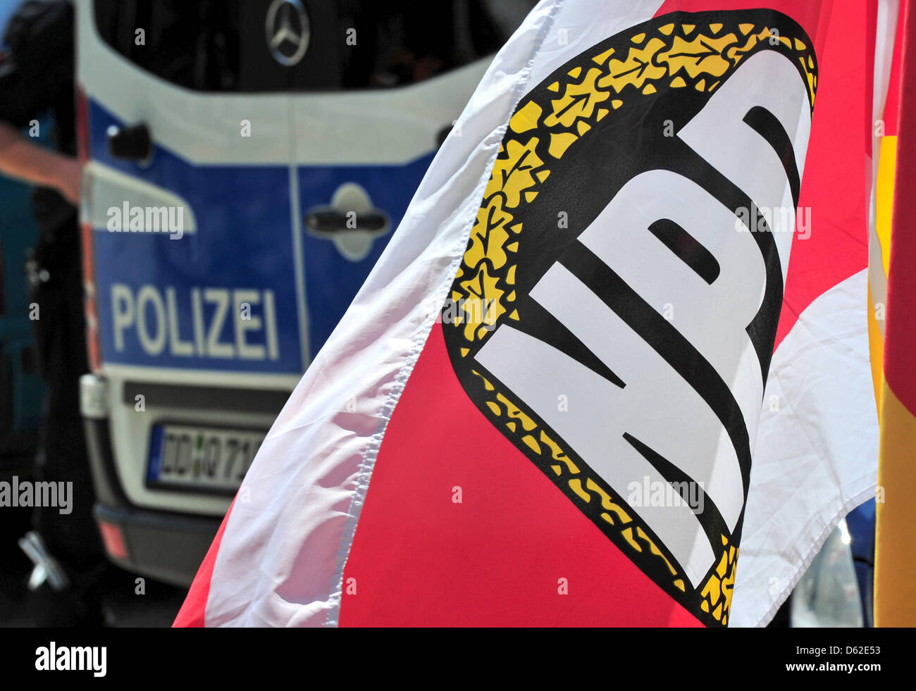 A flag of the far-right German nationalist party NPD flies next to a ...