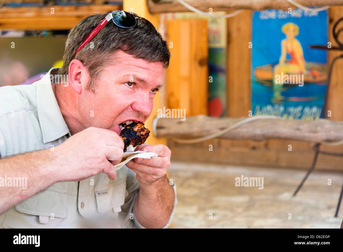 Man eating barbecued chicken leg hi-res stock photography and images ...