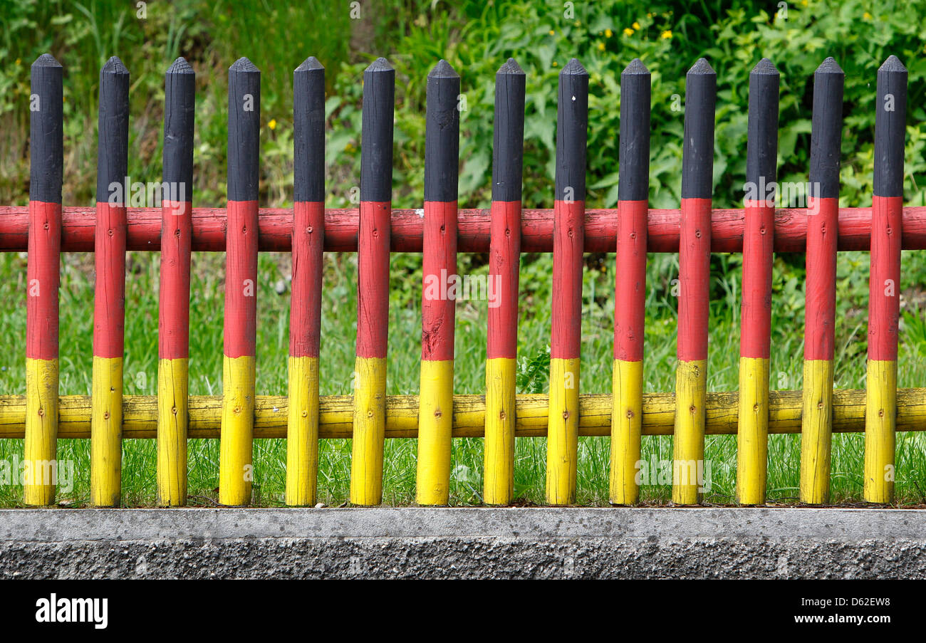 A fence is painted in black, red and gold. the German national colours ...