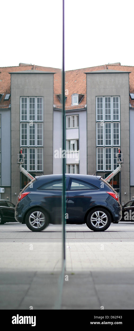 The stern of a small car mirrors in a window in Hanover, Germany, 21 ...