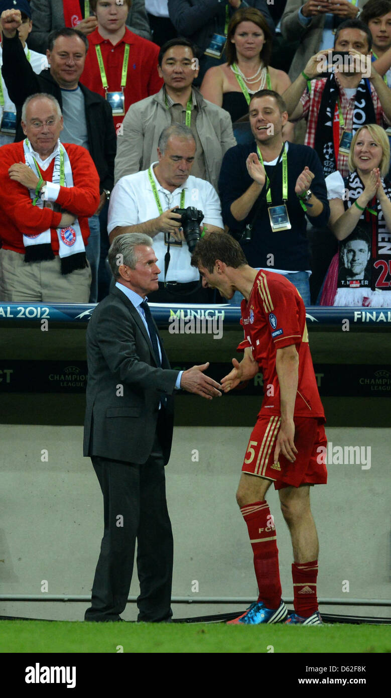 Munich's Thomas Mueller (R) shake hands with coach Jupp Heynckes during ...