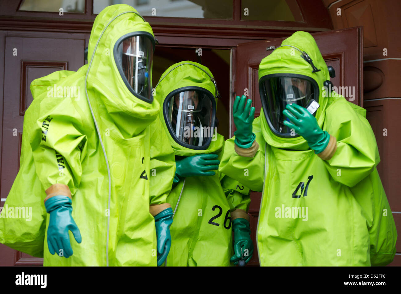 Firemen in protective suits stand in front of the chemistry department ...