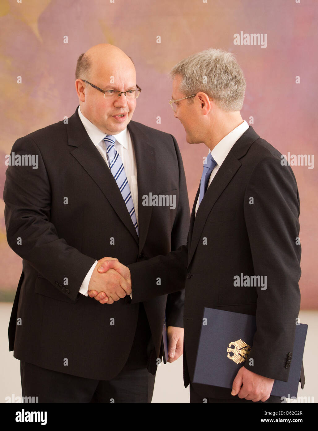 New German Environment Minister Peter Altmaier (L) stands next to out ...