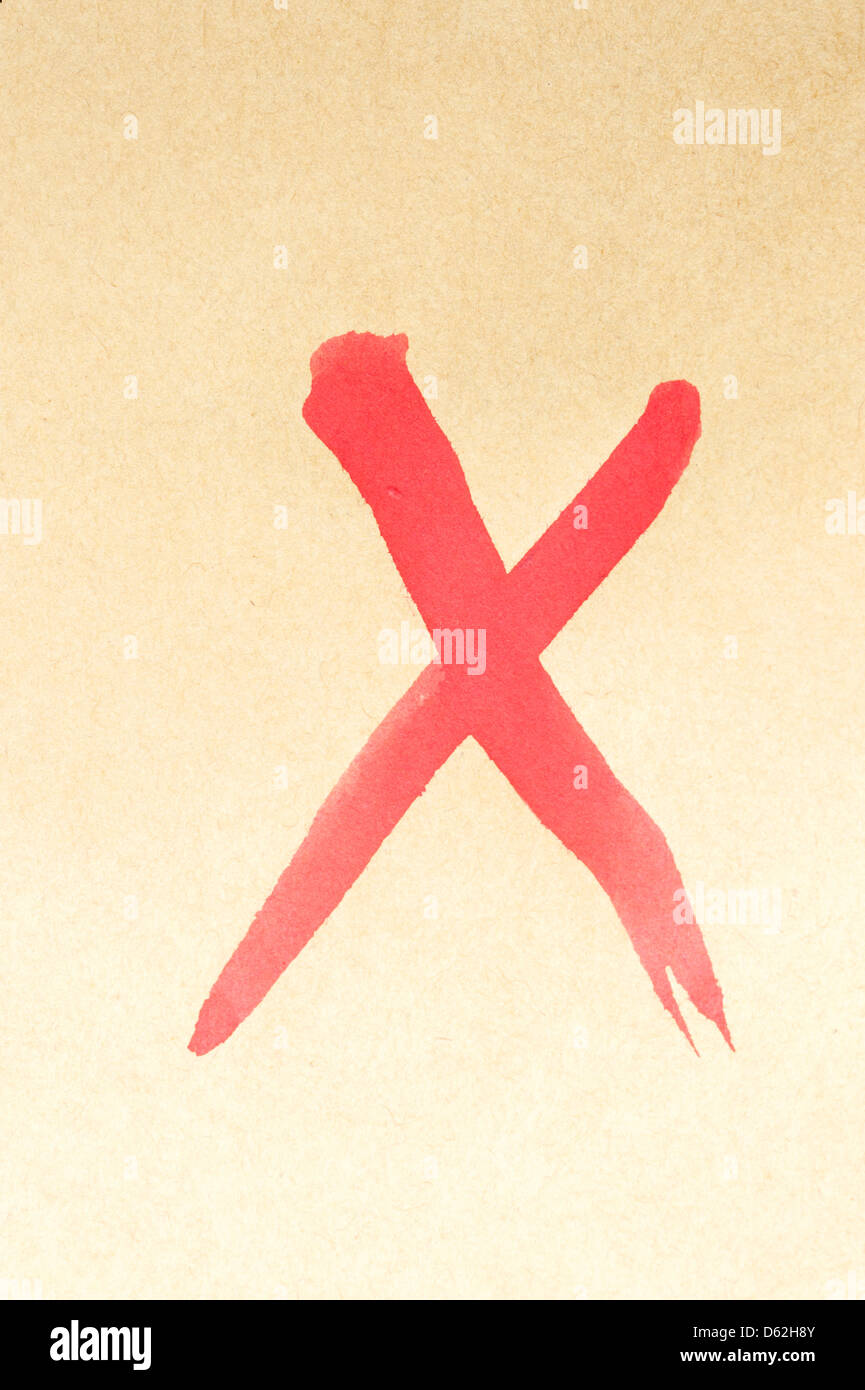 Cross mark symbol written on brown paper Stock Photo - Alamy