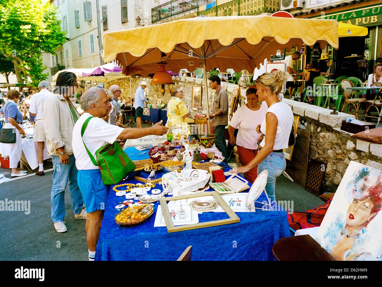 Bargaining at a market stall at the Antbes antiques street market ...