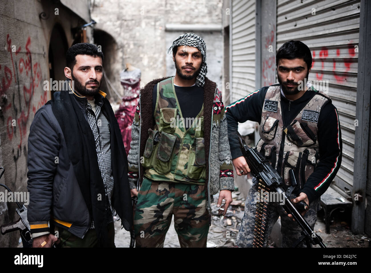 Three fighters of the Free Syrian Army pose for a portrait near the ...