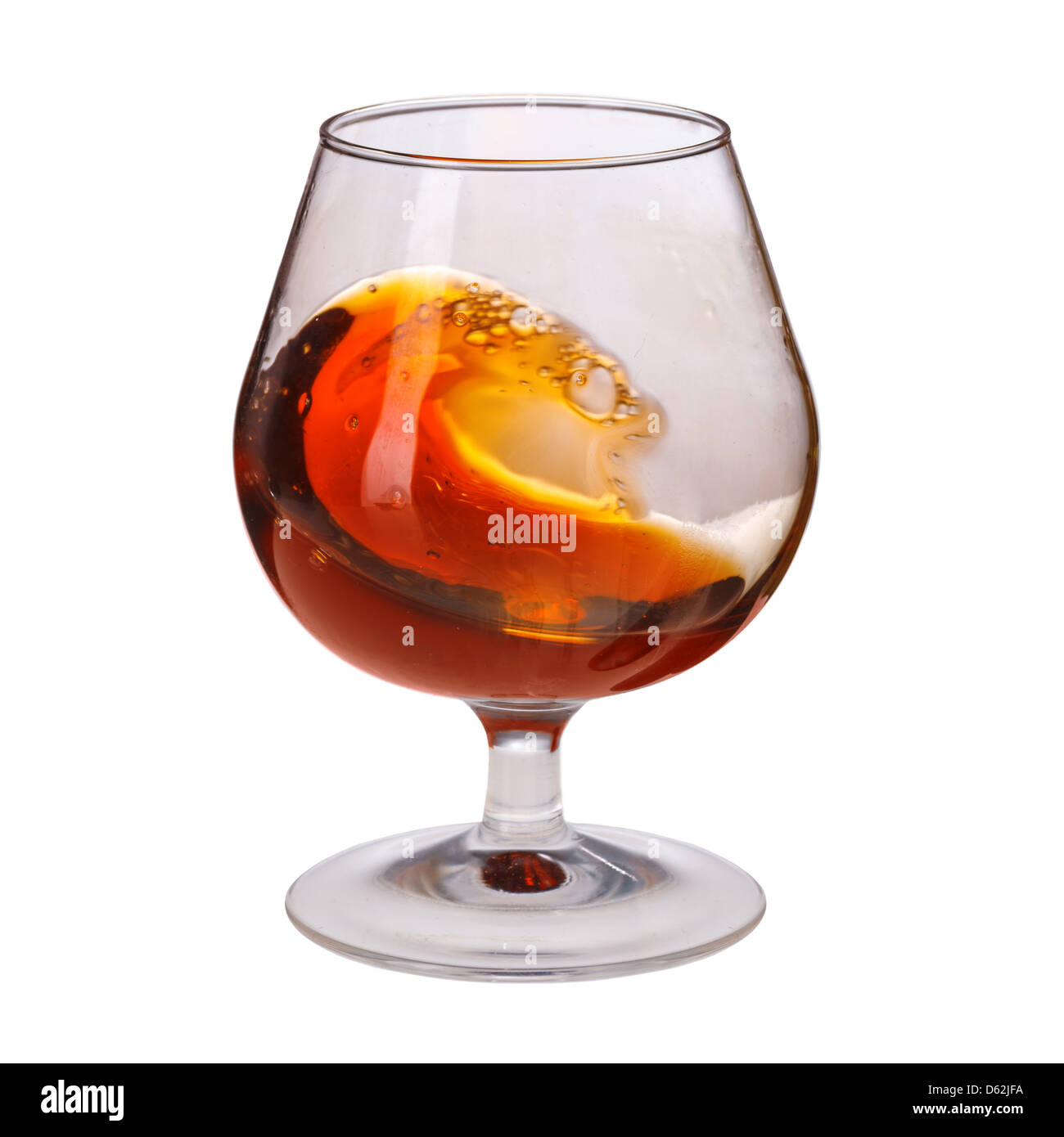Splash of cognac in glass on white background Stock Photo - Alamy